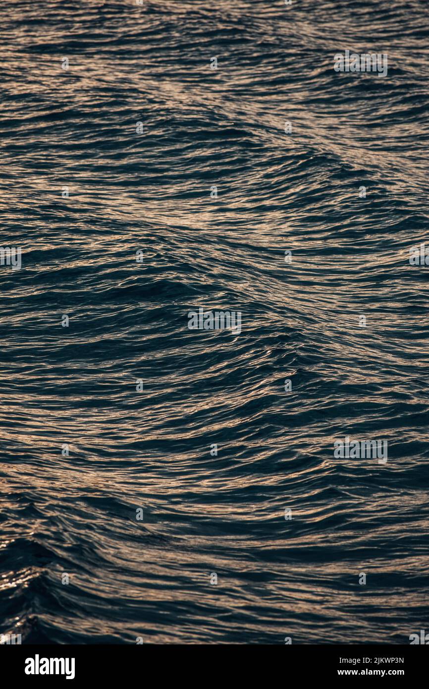 Blue calm sea waves under the sunlight Stock Photo - Alamy