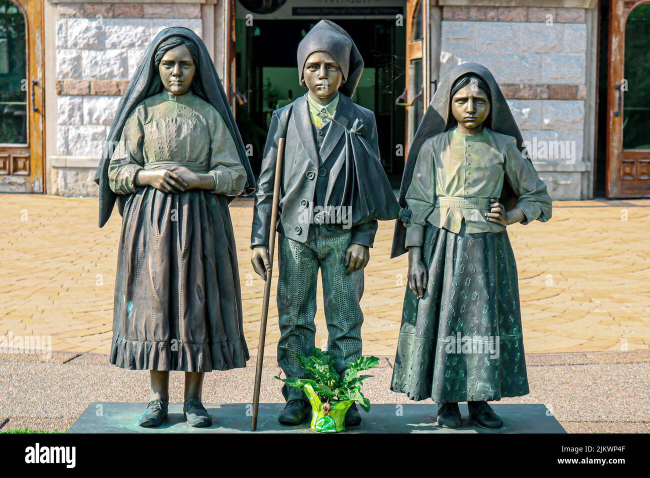 A close-up shot of the three little shepherds statues in front of the ...