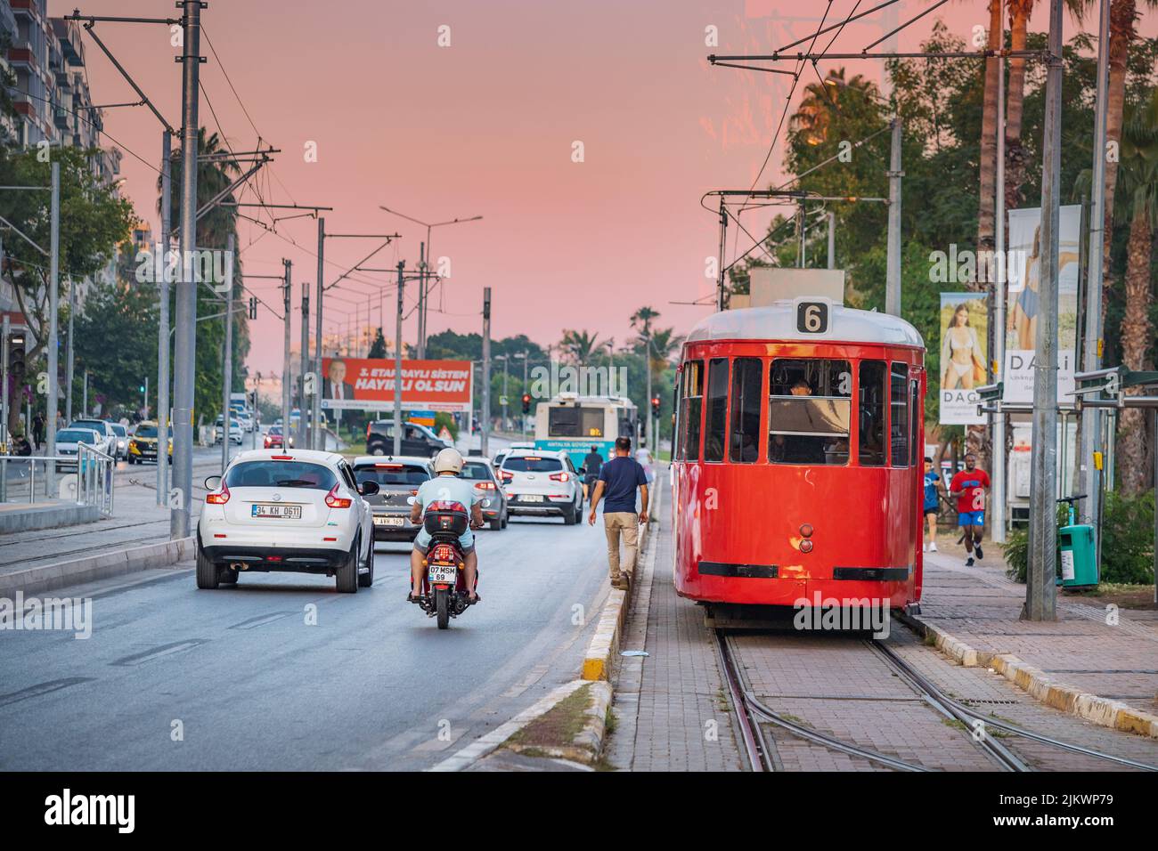 17 June 2022, Antalya, Turkey: Red retro tram with passengers and cars ...