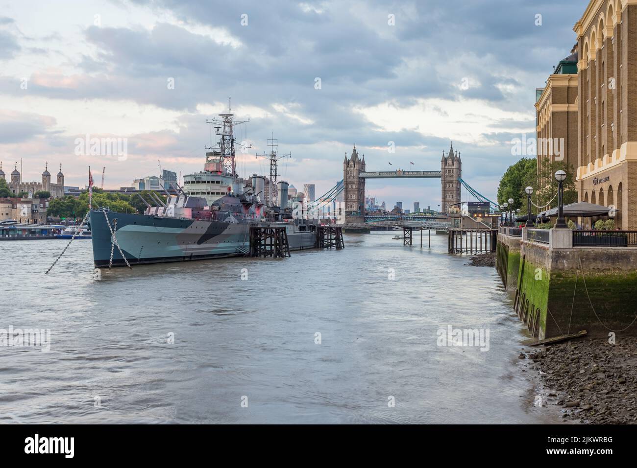 HMS Belfast lights up in red alongside Tower Bridge in London to ...