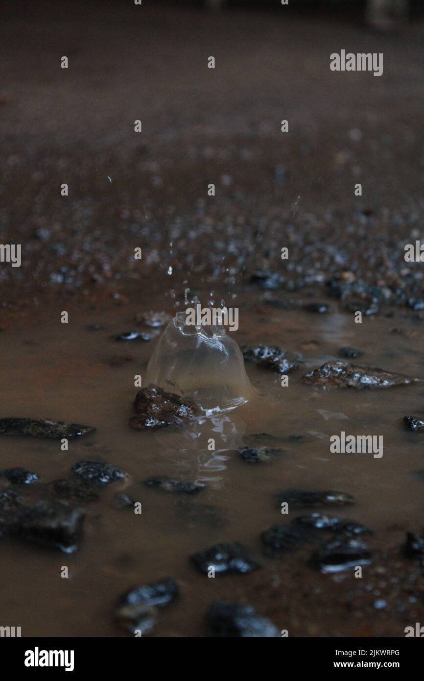 A vertical shot of a water drop on the ground Stock Photo - Alamy