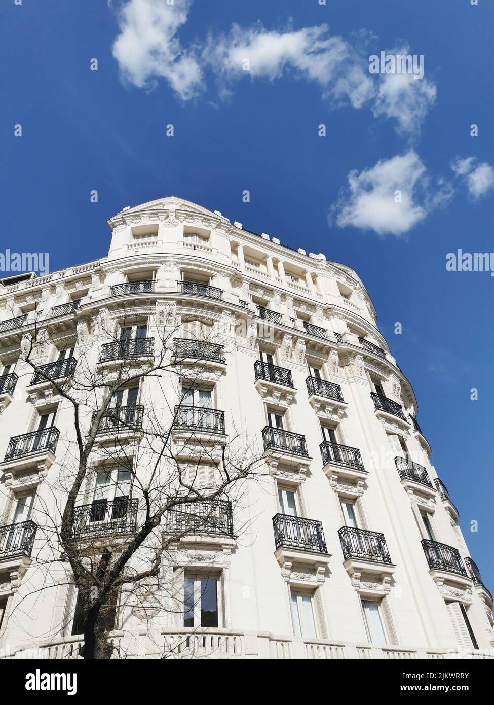 A vertical shot of a typical Spanish white building under a blue sky in ...