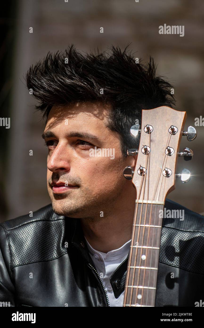 Face of boy with the headstock of a guitar in nature Stock Photo - Alamy