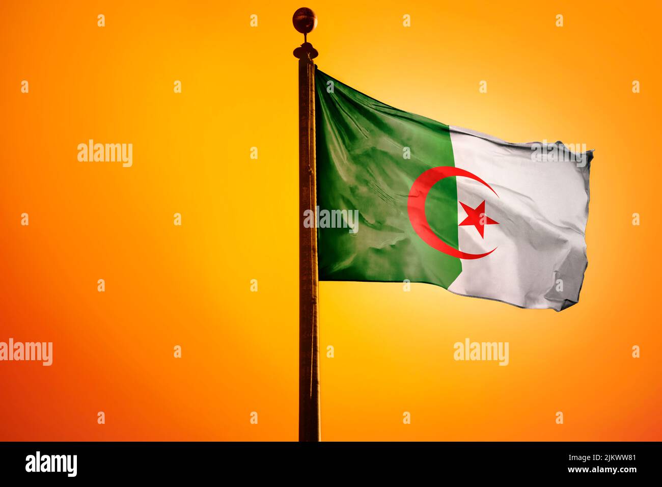A digital illustration of the flag of Algeria waving against a bright ...