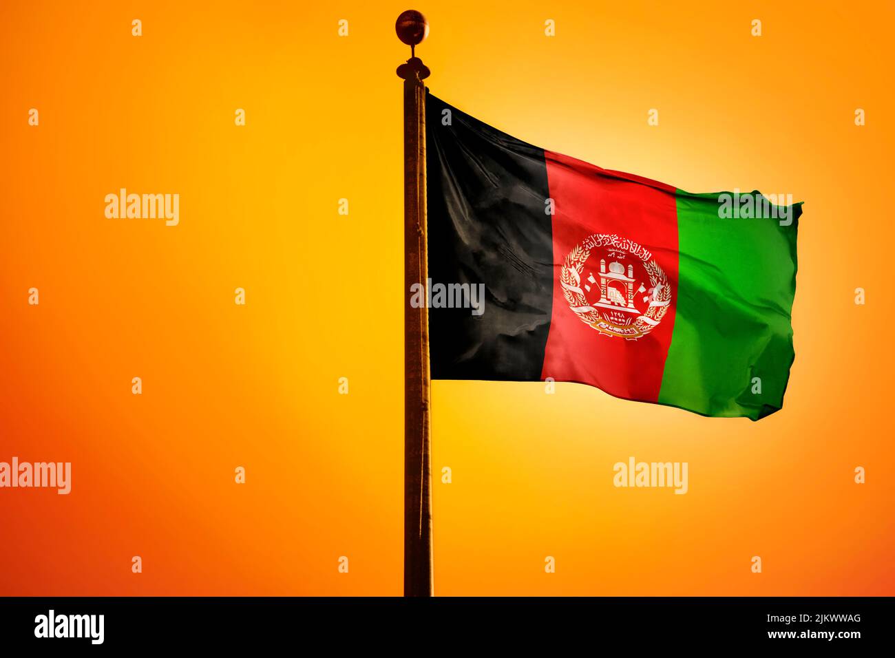 A digital illustration of the old flag of Afghanistan waving against a ...