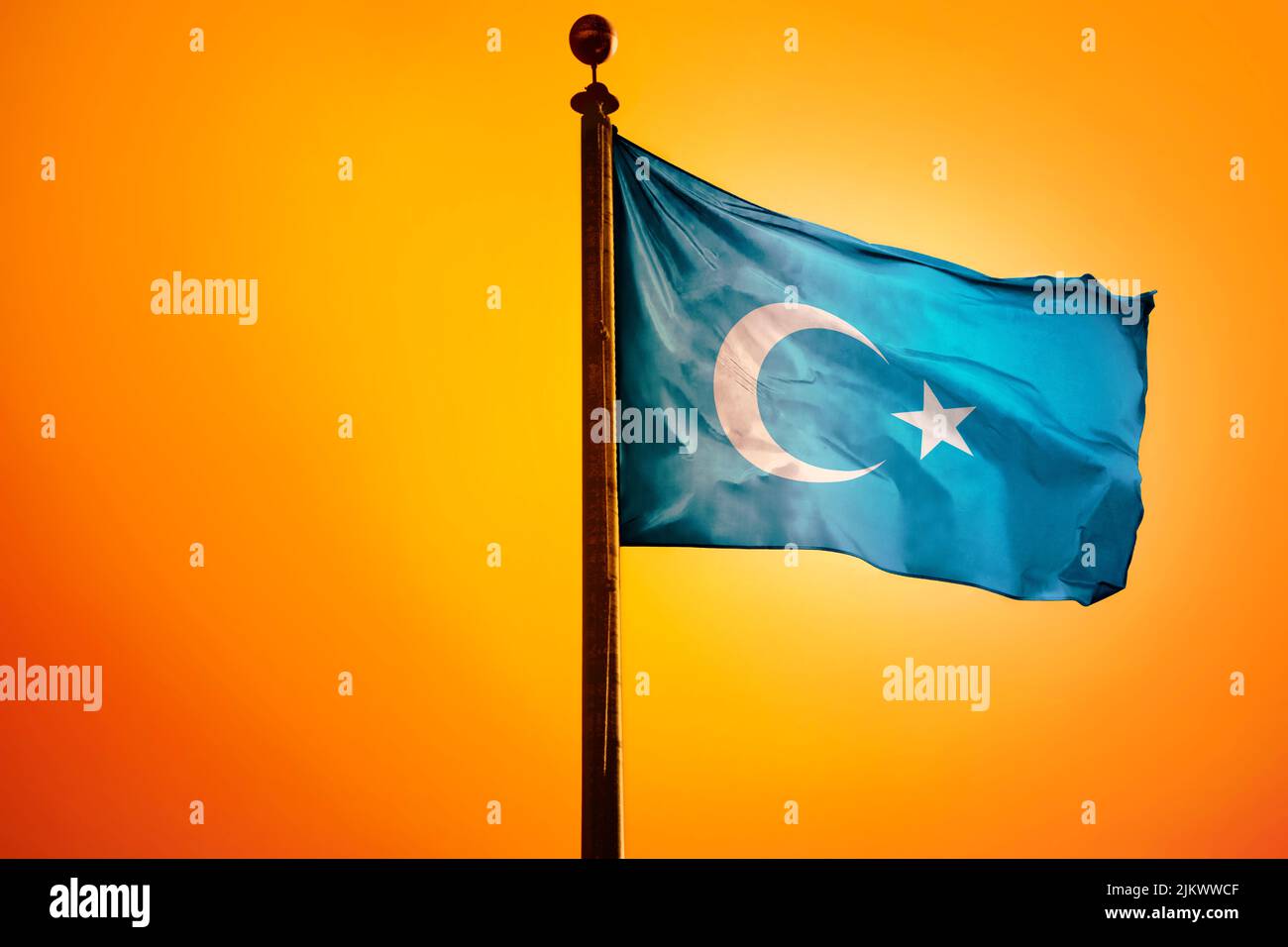 The flag of the First East Turkistan Republic waving against a bright ...