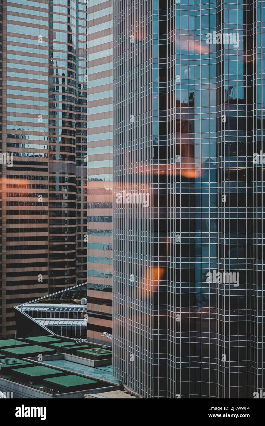 A vertical shot of glass high raised building facade Stock Photo - Alamy