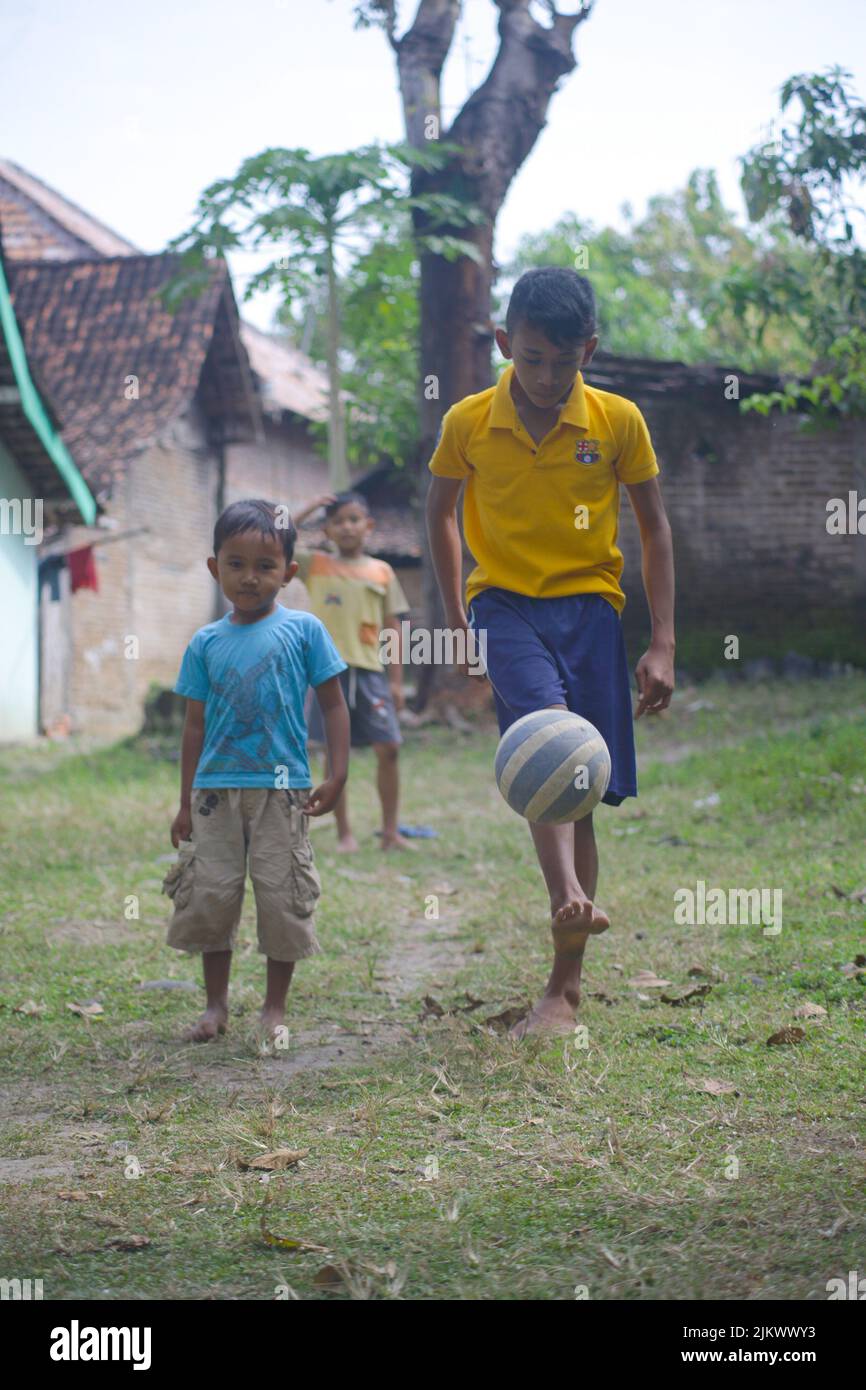 Jakarta, Indonesia - Asian boy playing soccer. Asian boy playing ...