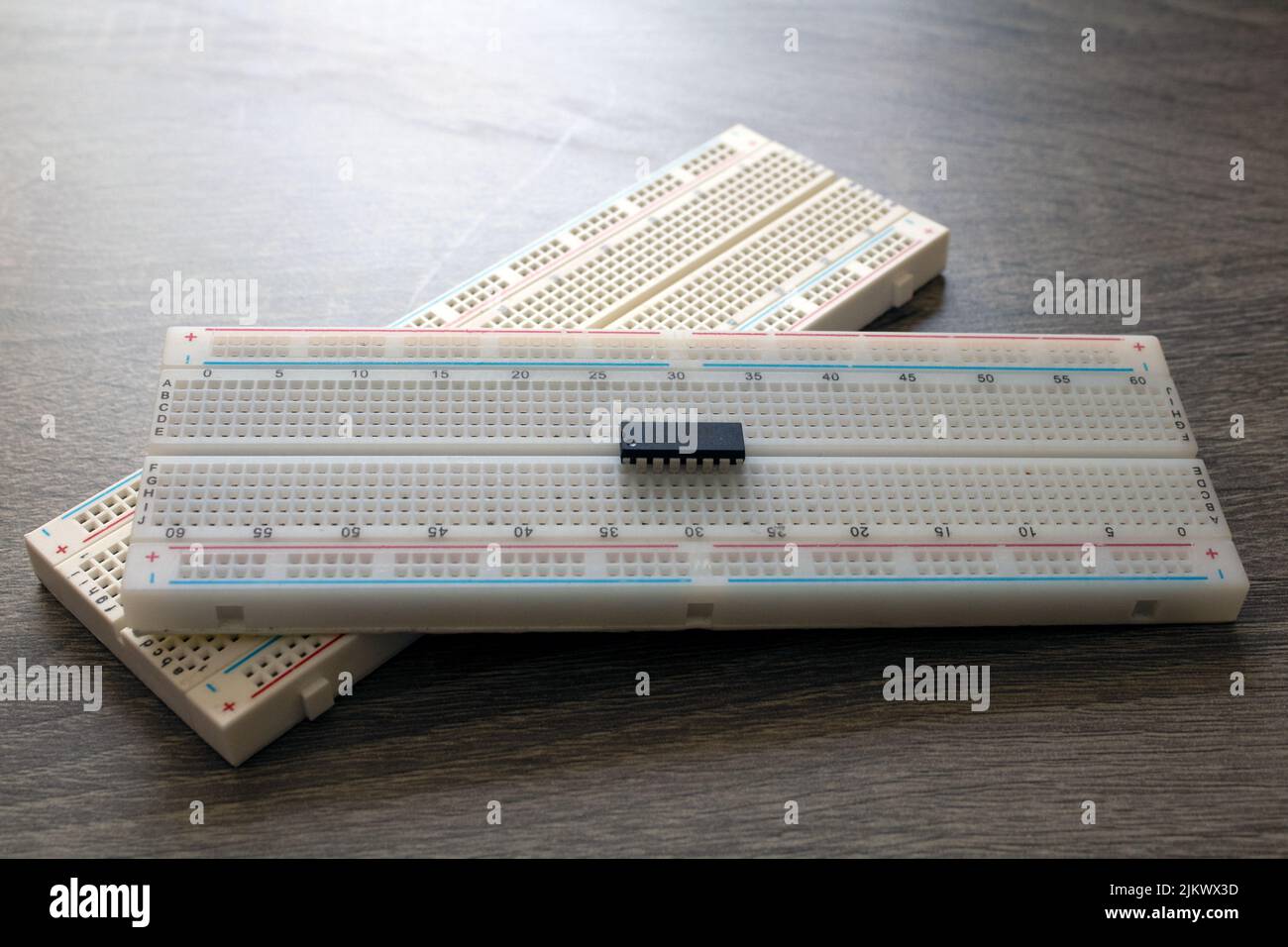A microchip on a stacked breadboard for electrical engineering on a ... A microchip on a stacked breadboard for electrical engineering on a ...
