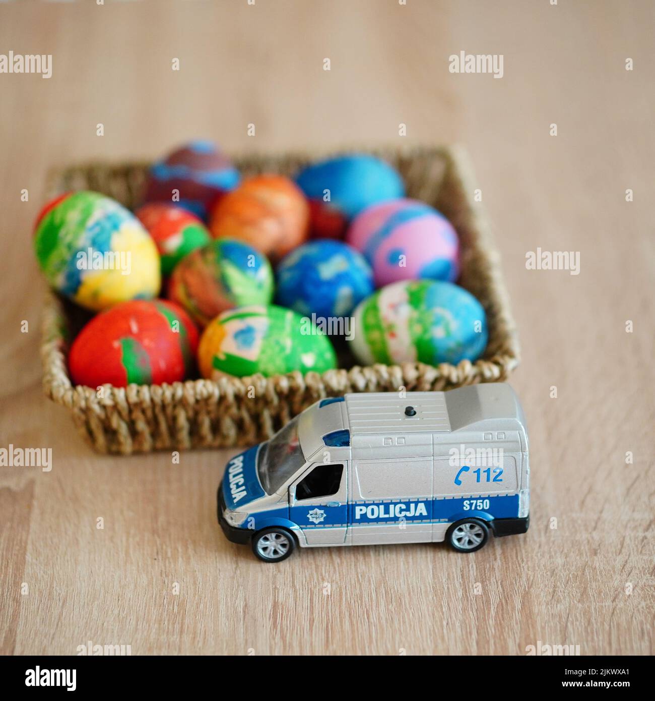 A toy model Police van and colored cooked Easter eggs in a basket Stock ...