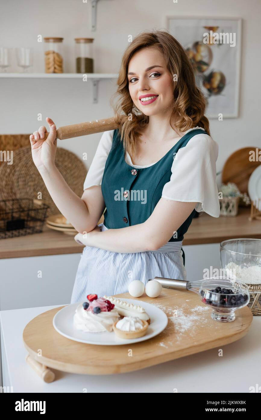 Pretty adult girl cooking in the kitchen Stock Photo - Alamy