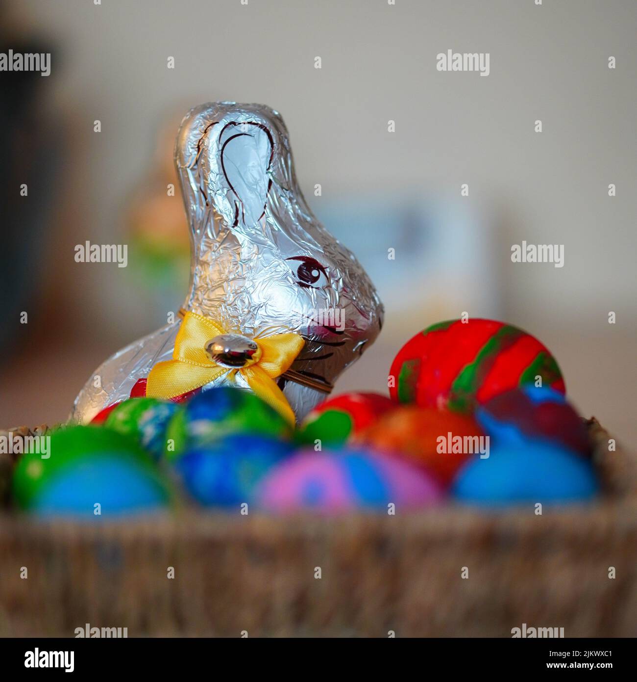 An Easter bunny candy in a basket of Easter eggs Stock Photo - Alamy