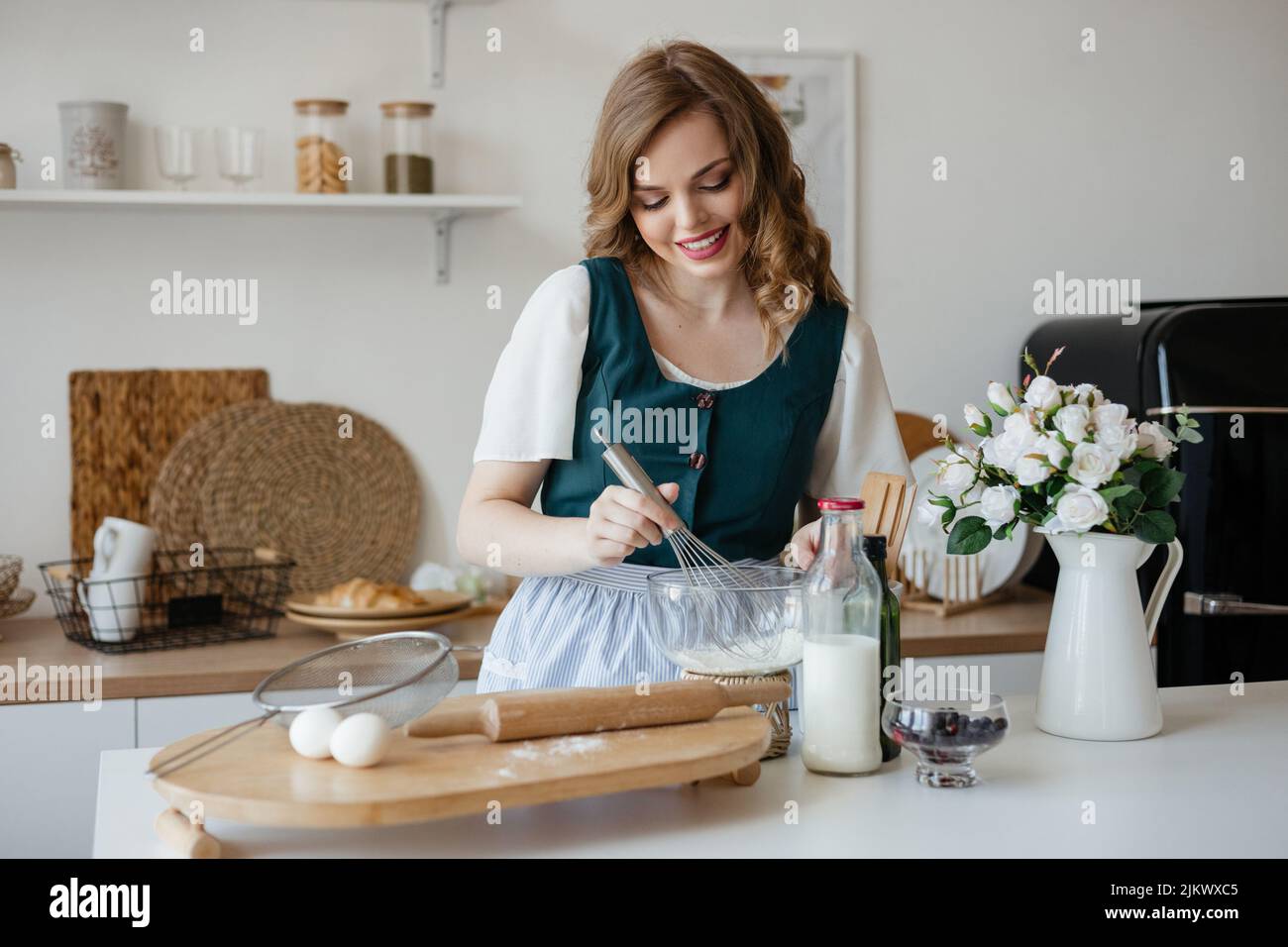 Pretty adult girl cooking in the kitchen Stock Photo - Alamy