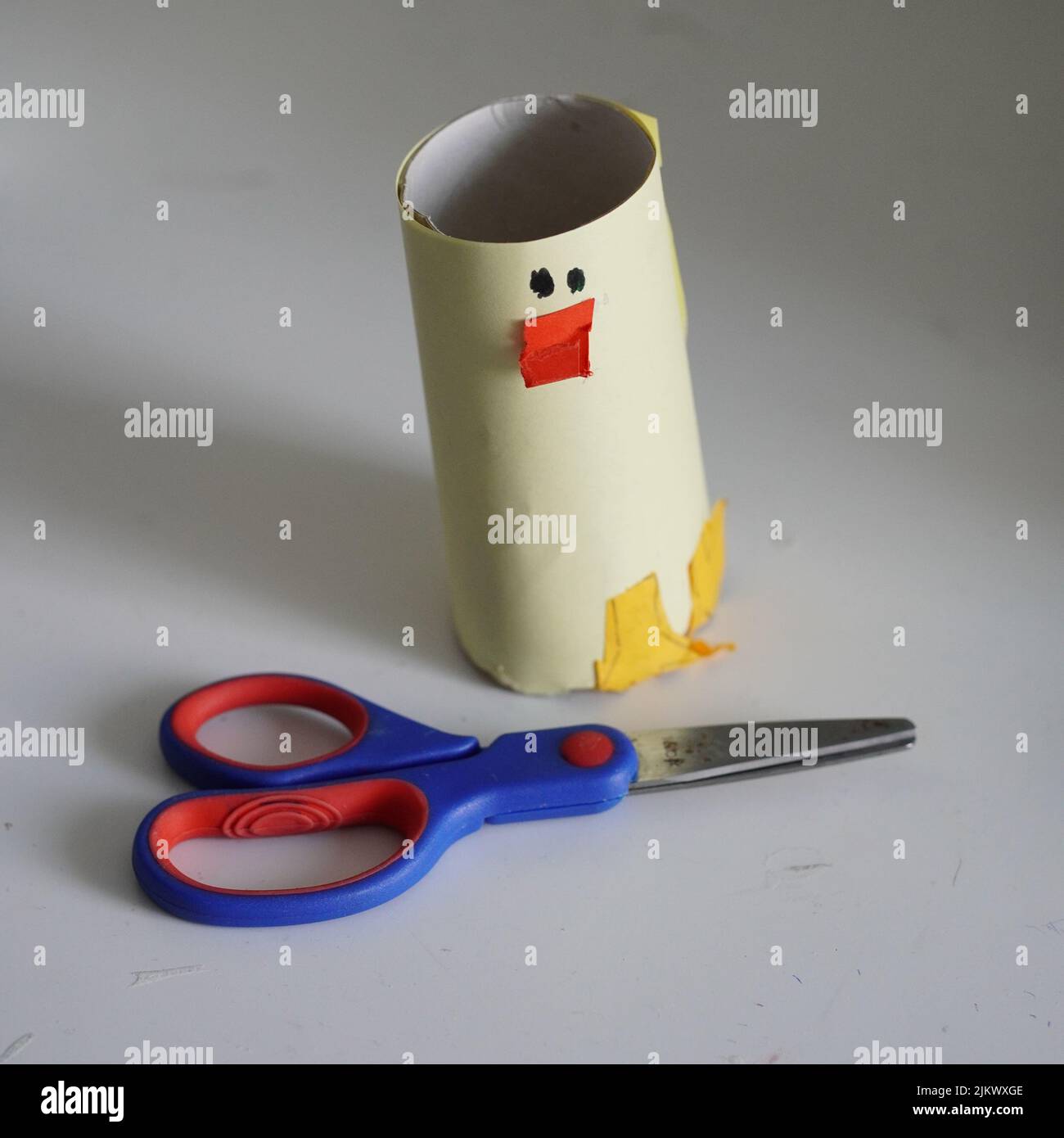 A funny paper craft and scissors Stock Photo - Alamy