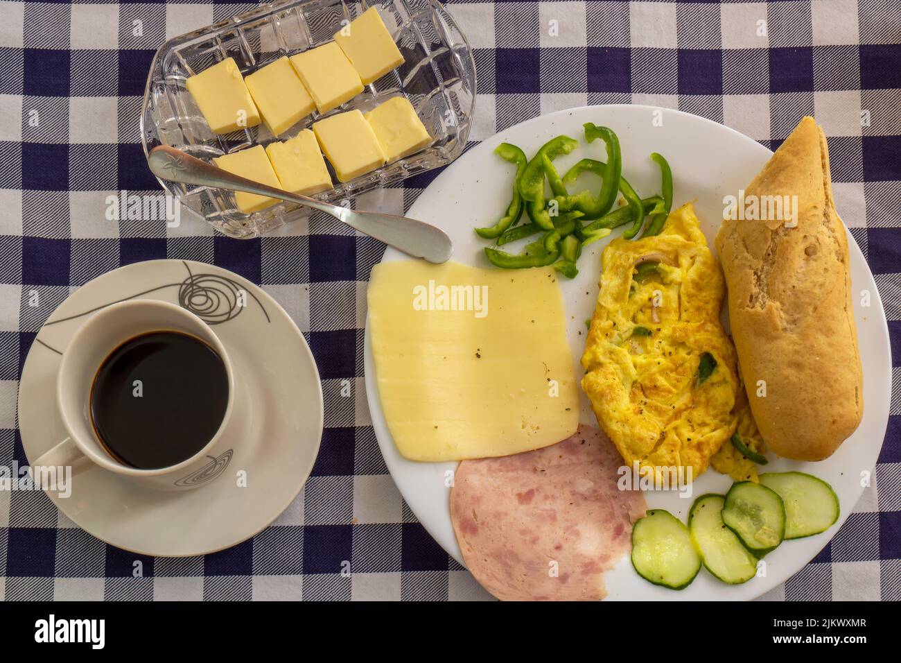 A top view of a breakfast omelette with bacon,cheese, bread and ...