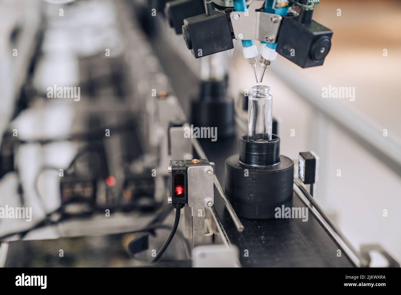 A perfume machinery manufacturing and filling bottles in a factory ...