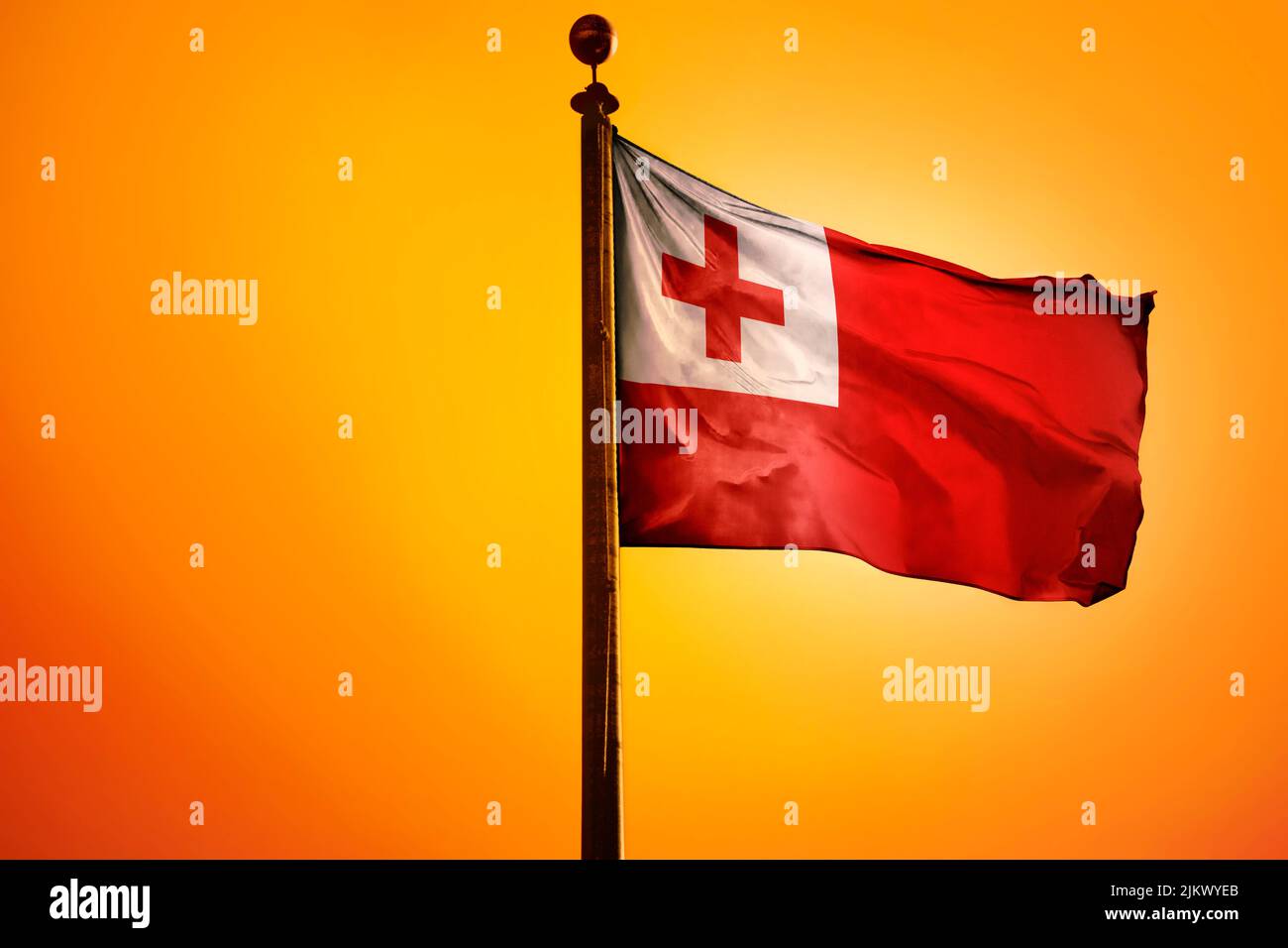 A 3D rendering of the Tonga flag waving in the wind with an orange ...