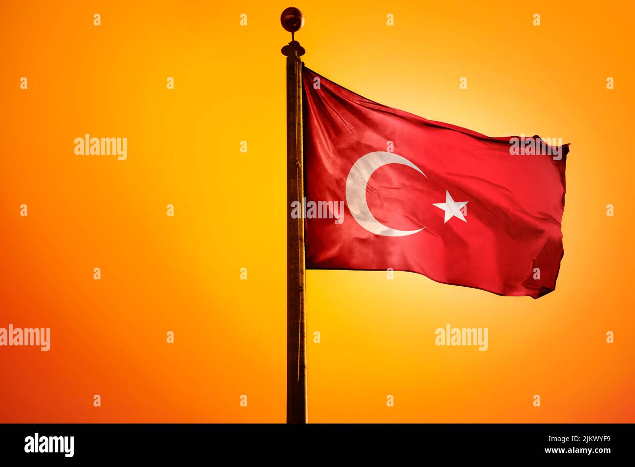 A 3D rendering of a waving flag of Turkey on a pole on an orange ...