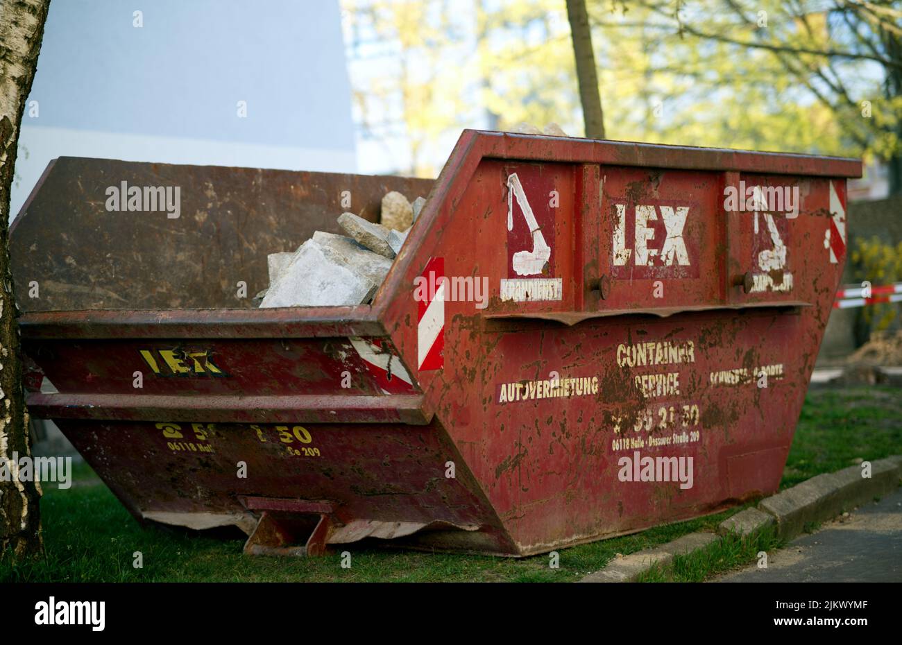 A red garbage container in the residential area Stock Photo - Alamy
