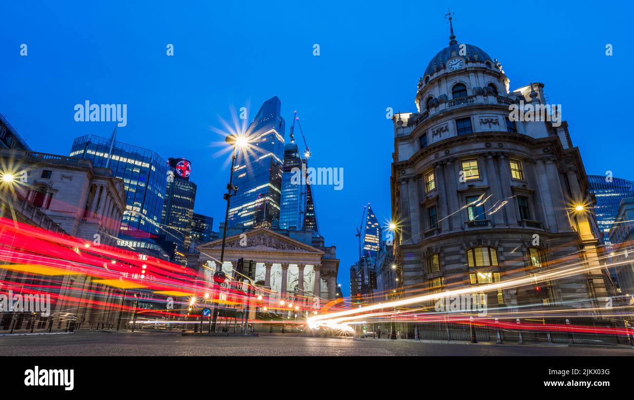A long exposure capturing the traffic trails at a busy junction where ...