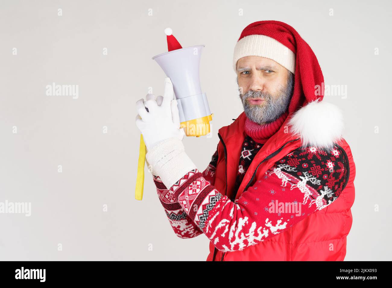 New Year and Christmas concept. Santa Claus holds a loudspeaker in his ...
