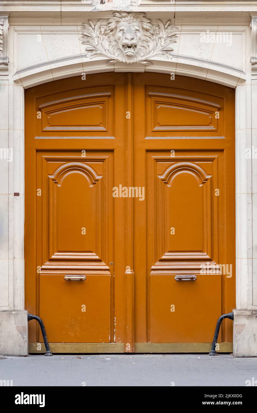 Paris, an ancient wooden door, beautiful facade in the Opera district ...