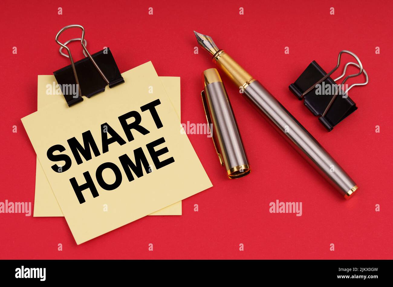 Business concept. On a red background, a pen and stickers with the ...