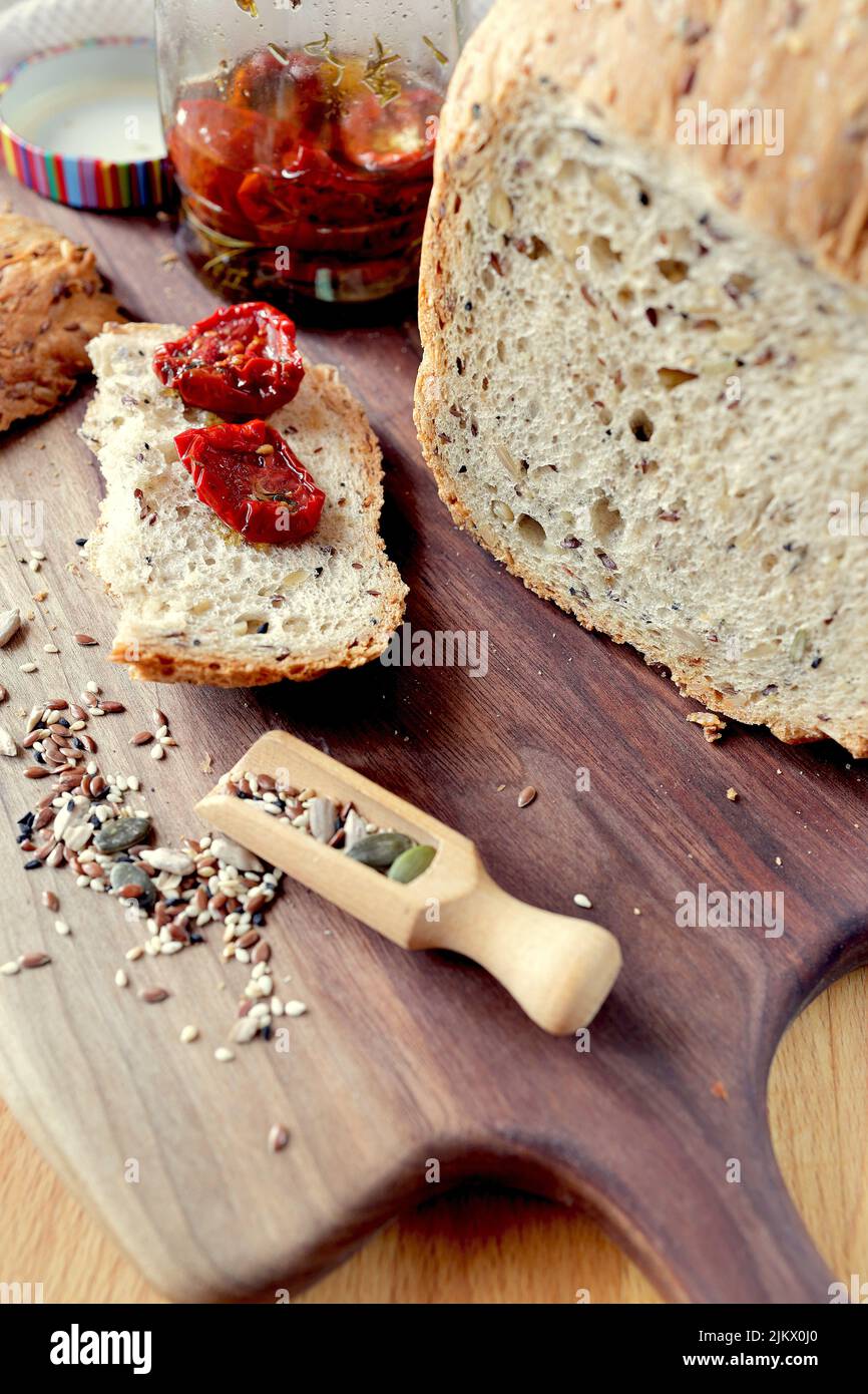 Sliced rye bread on cutting board. Whole grain rye bread with seeds ...