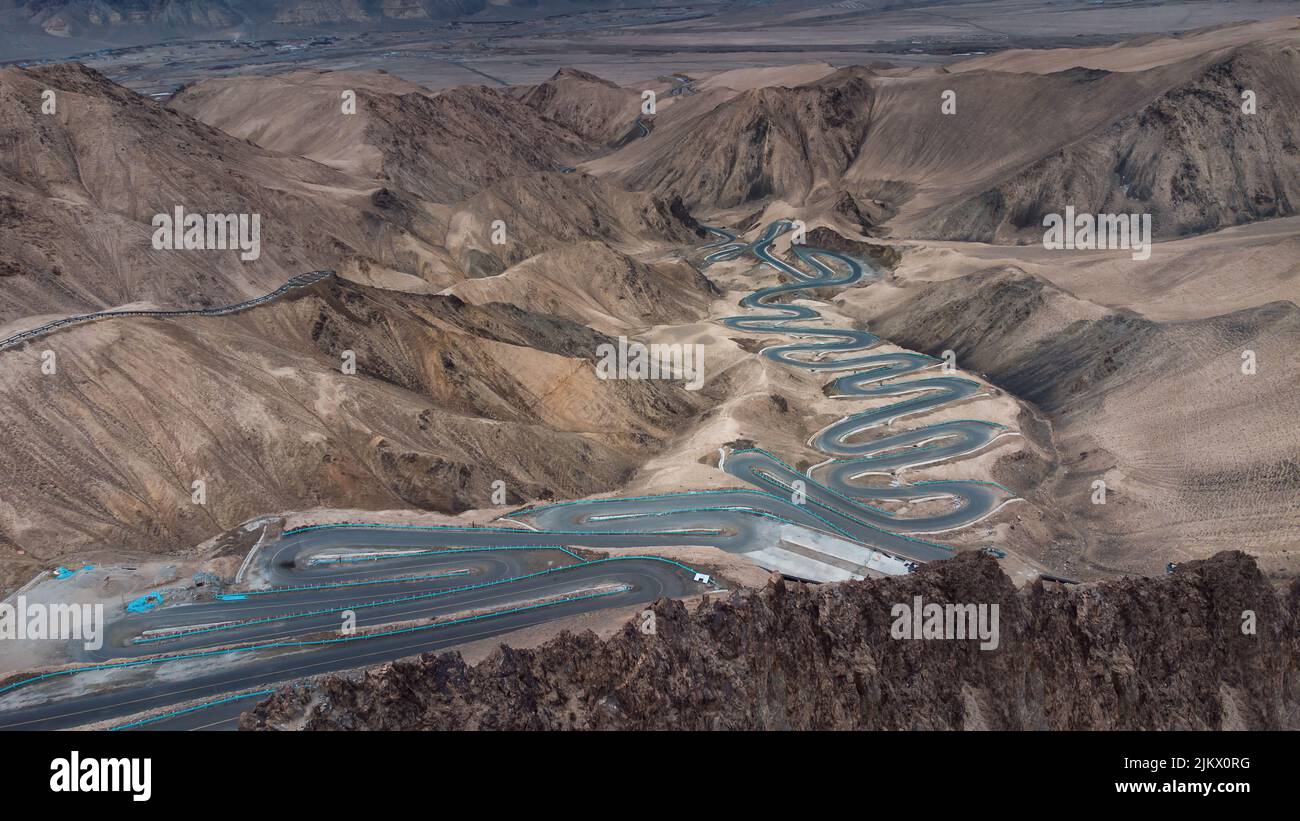 An aerial view of the vast canyon and curved roads of Logar in ...