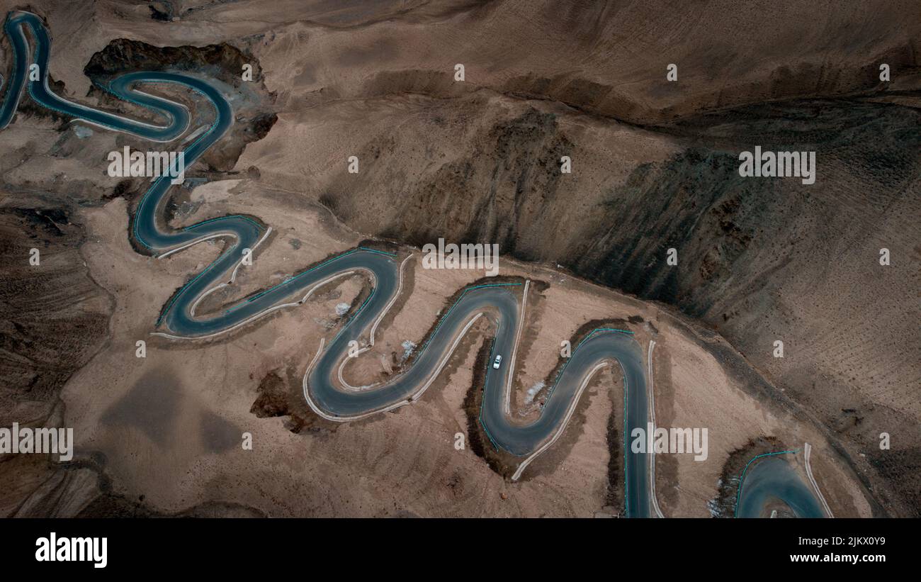 An aerial view of the vast canyon and curved roads of Logar in ...