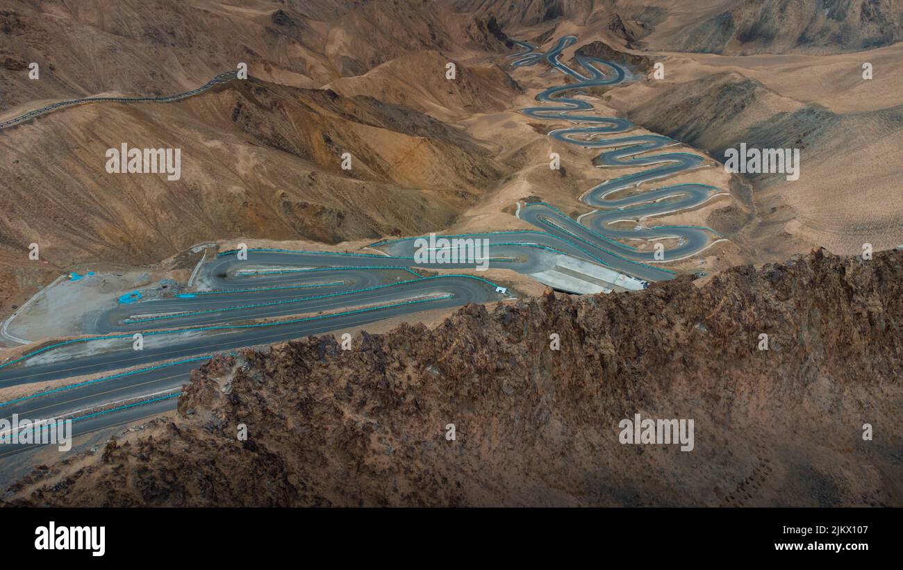 An aerial view of the vast canyon and curved roads of Logar in ...