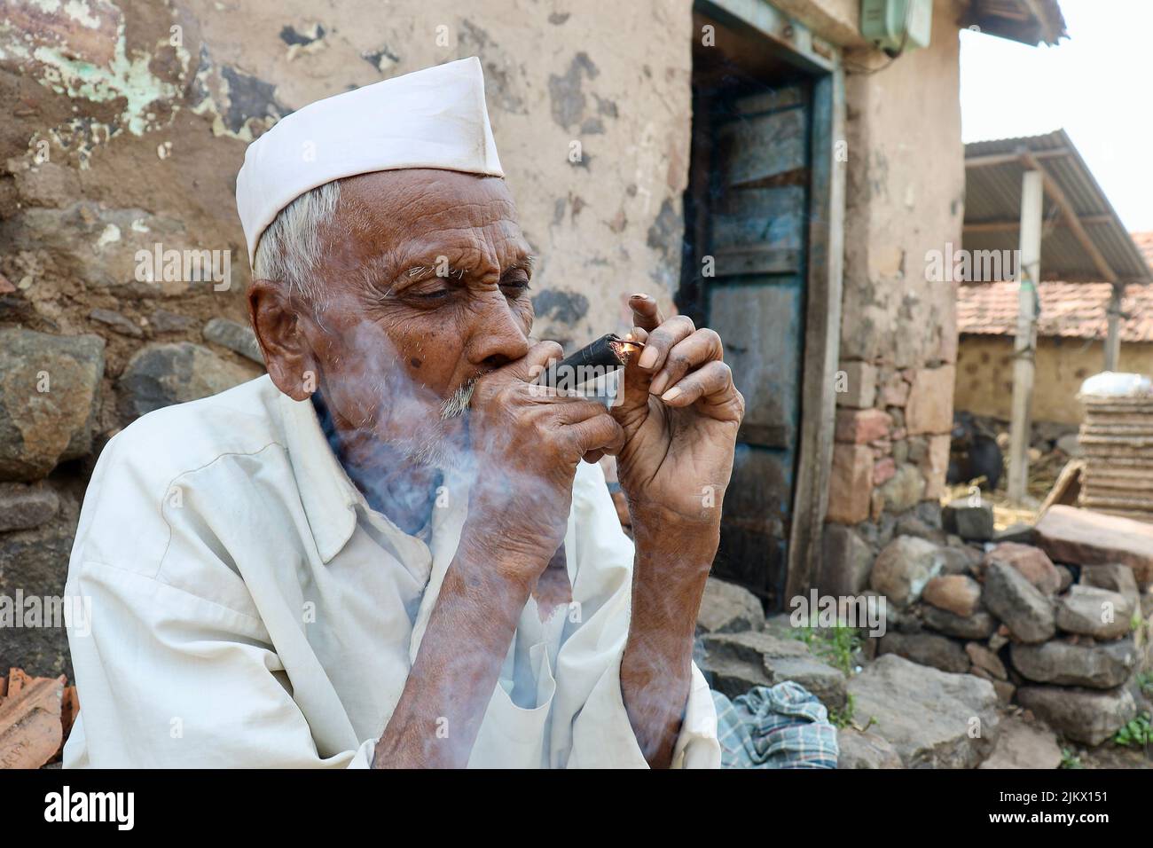 A selective focus of an Indian poor village old man in village attire ...