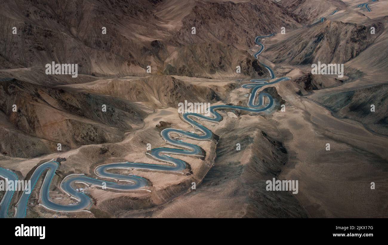 An aerial view of a winding race road in the hills of a desert Stock ...