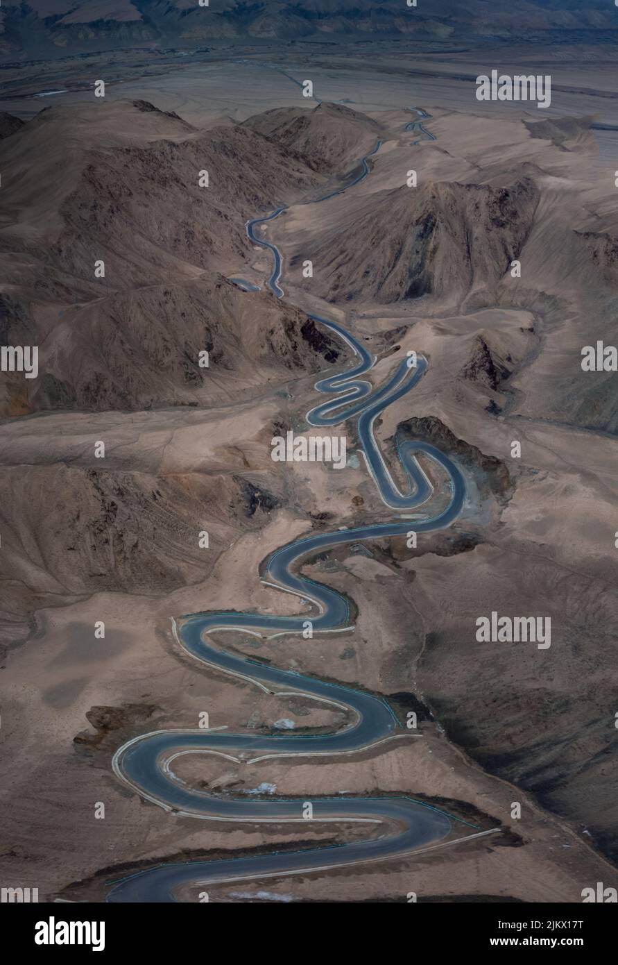 An aerial view of a winding race road in the hills of a desert Stock ...