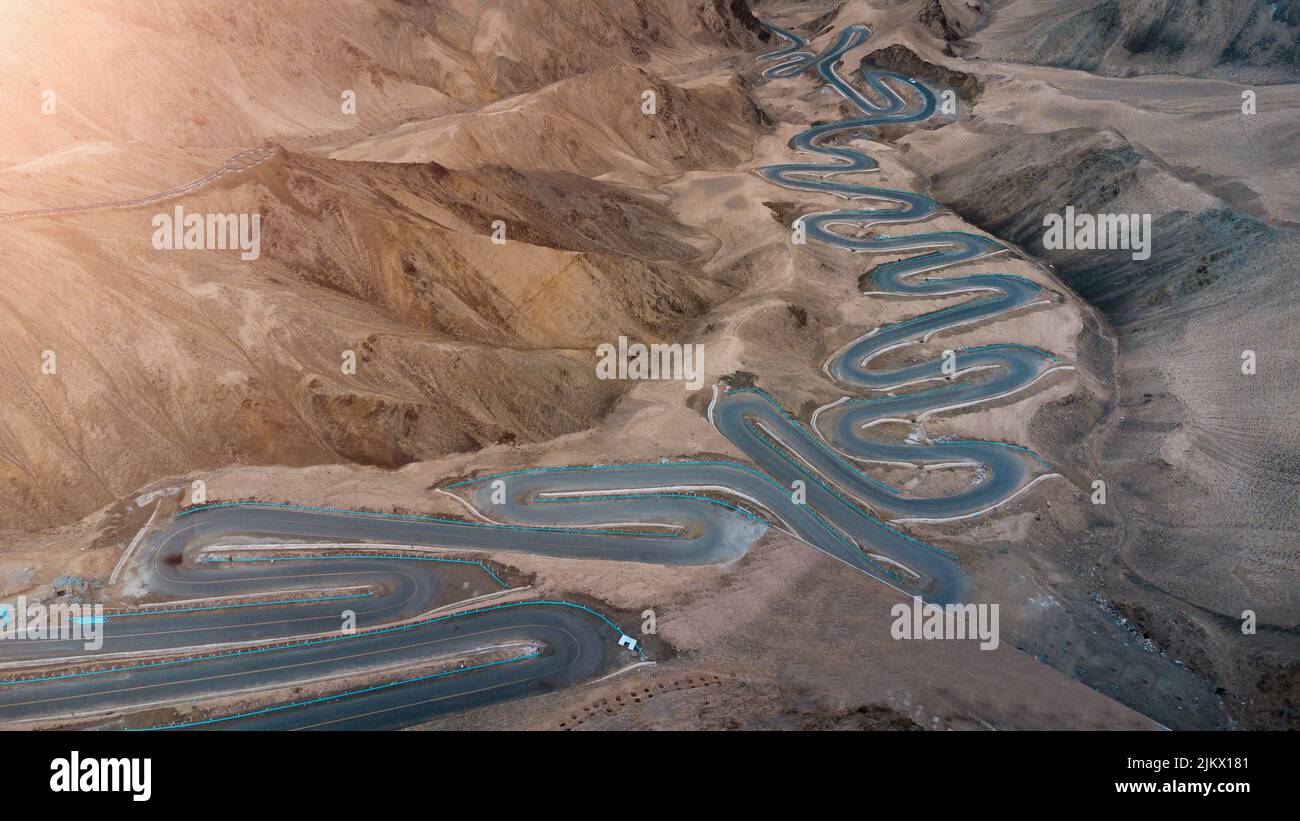 An aerial view of a winding race road in the hills of a desert Stock ...