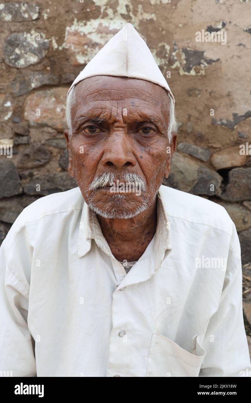 A headshot portrait of an old Indian man. A traditional north Karnataka ...