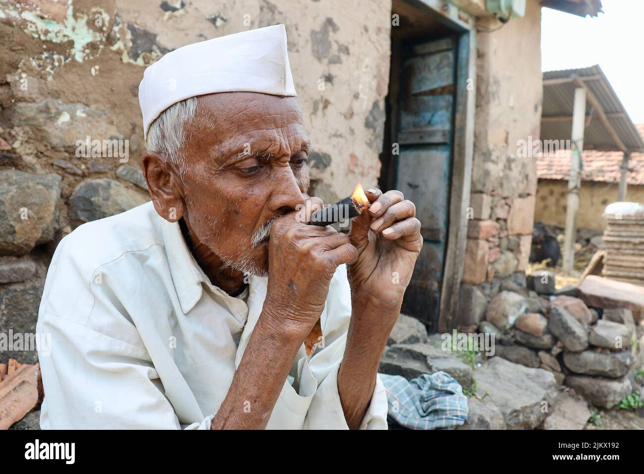 Indian man smoking cigarette hi-res stock photography and images - Alamy