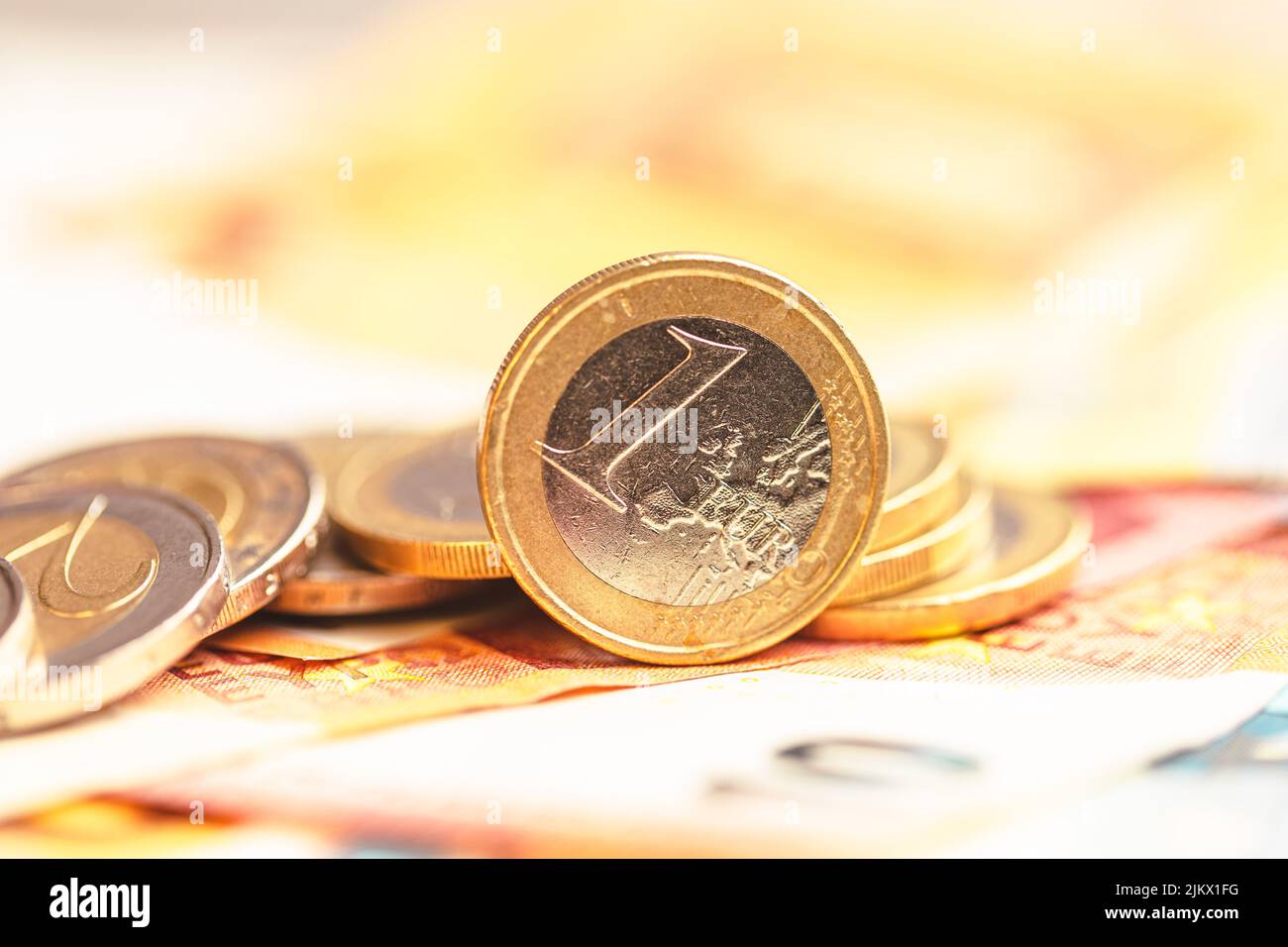 Euro coins on a paper euro banknotes Stock Photo - Alamy