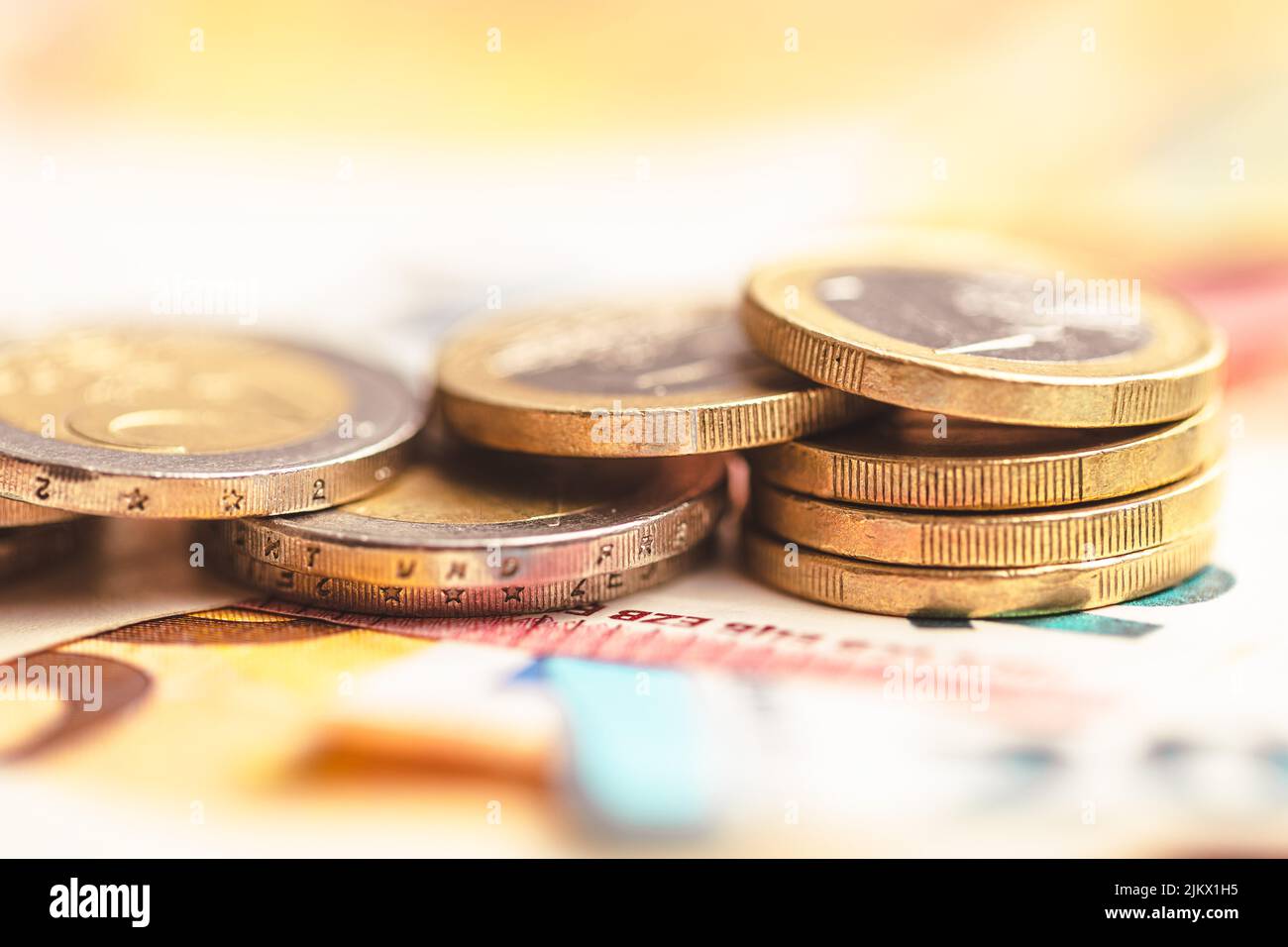 Euro coins on a paper euro banknotes Stock Photo - Alamy