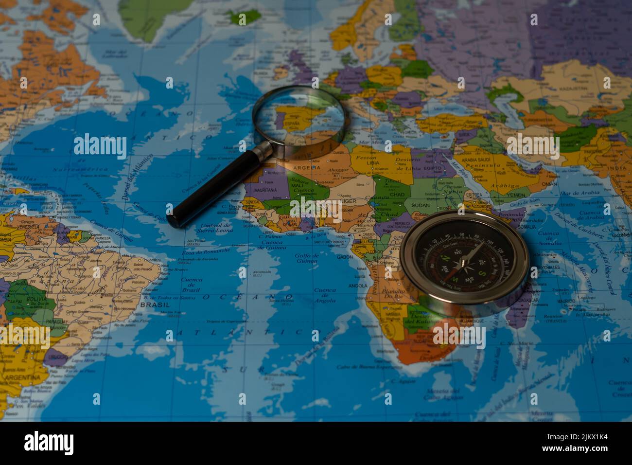 zenithal view world map with compass and magnifying glass Stock Photo ...