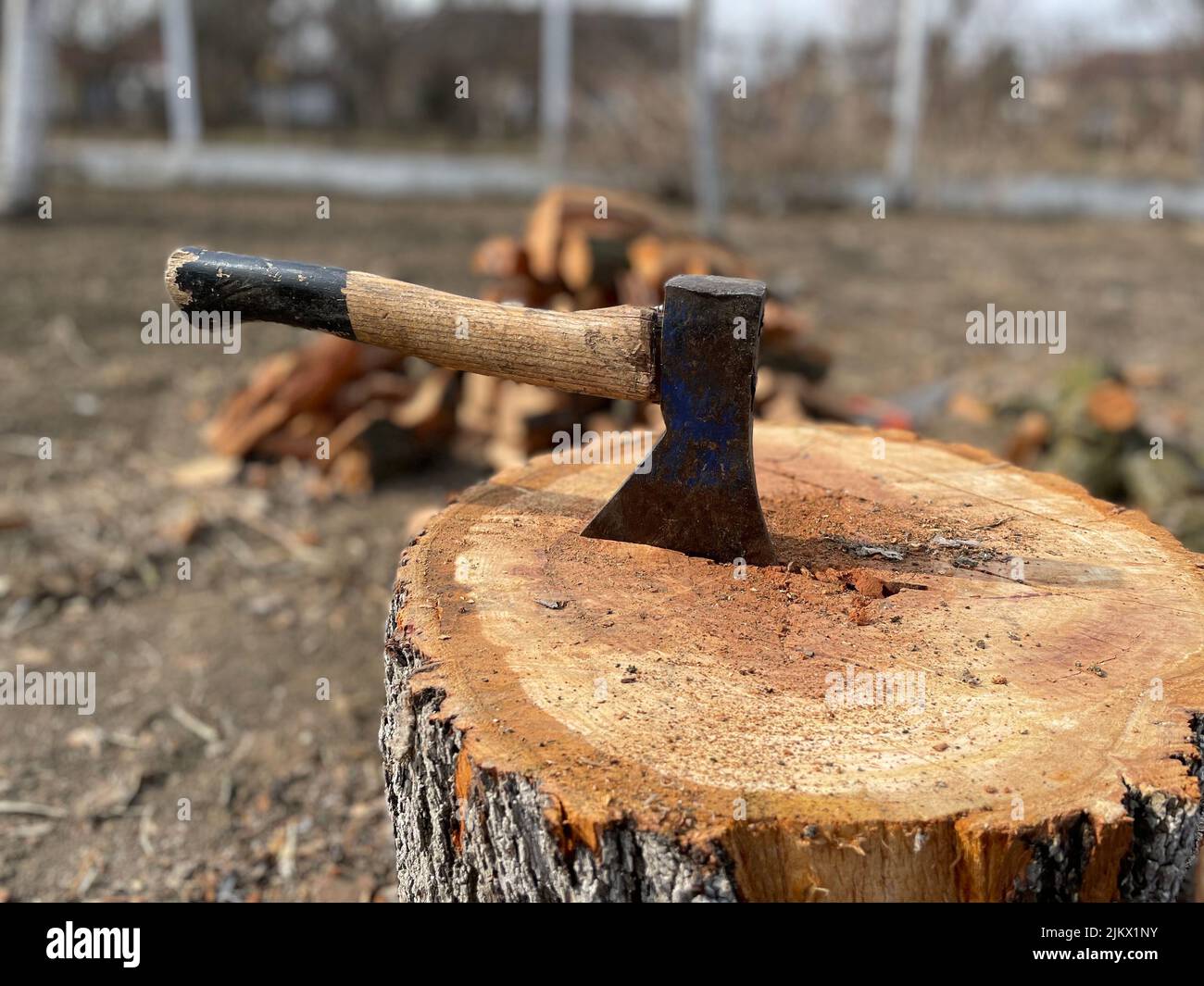 An old ax with a wooden handle stuck in a wooden log Stock Photo - Alamy