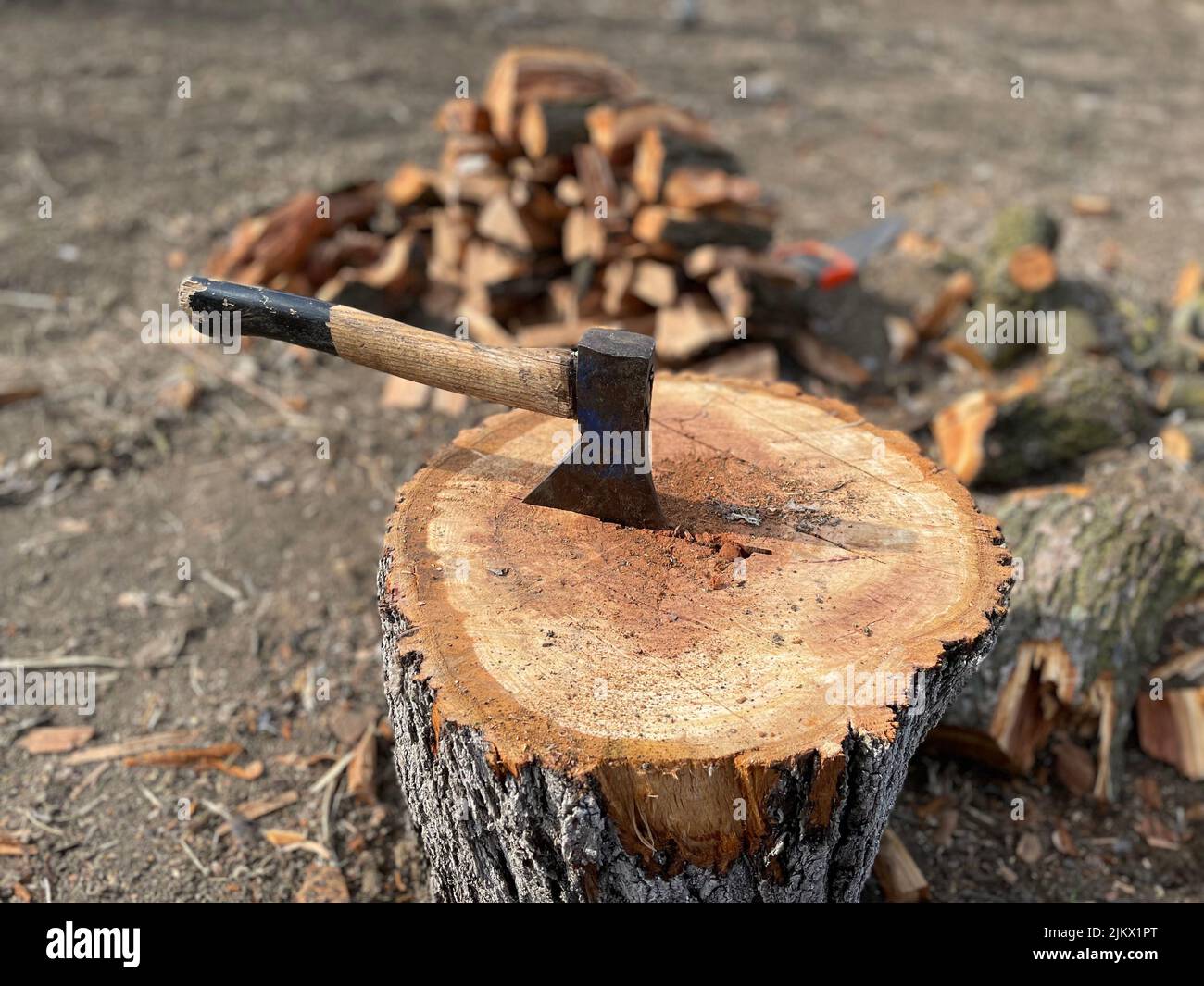 An old ax with a wooden handle stuck in a wooden log Stock Photo - Alamy