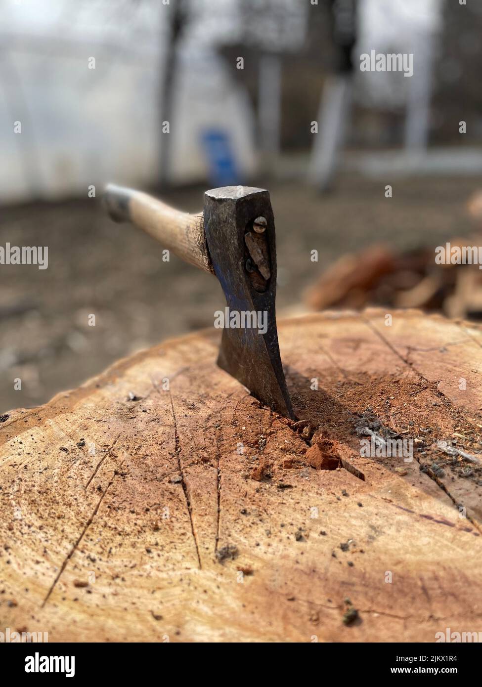An old ax with a wooden handle stuck in a wooden log Stock Photo - Alamy