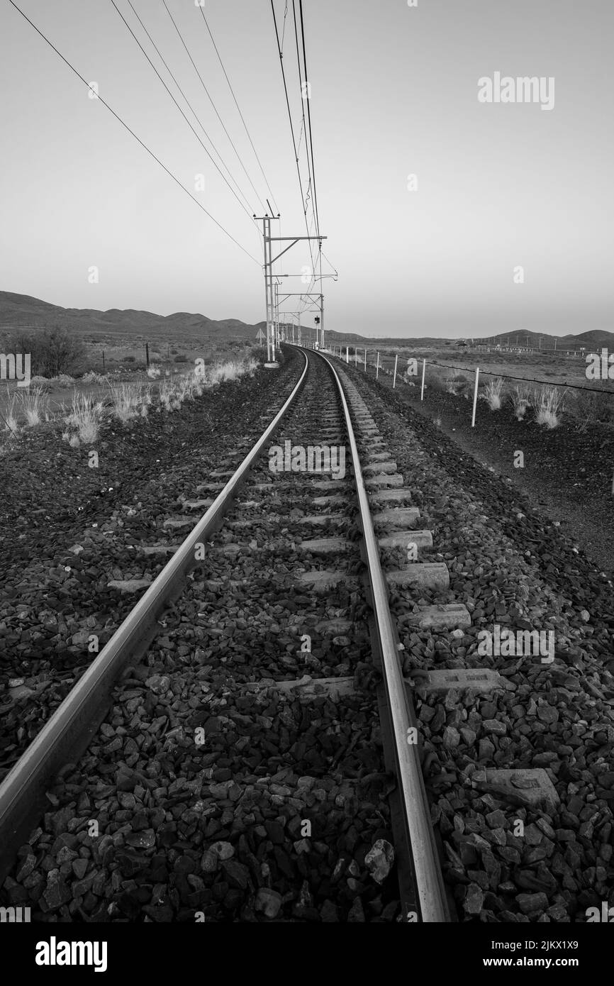 A grayscale shot of a train railway Stock Photo - Alamy