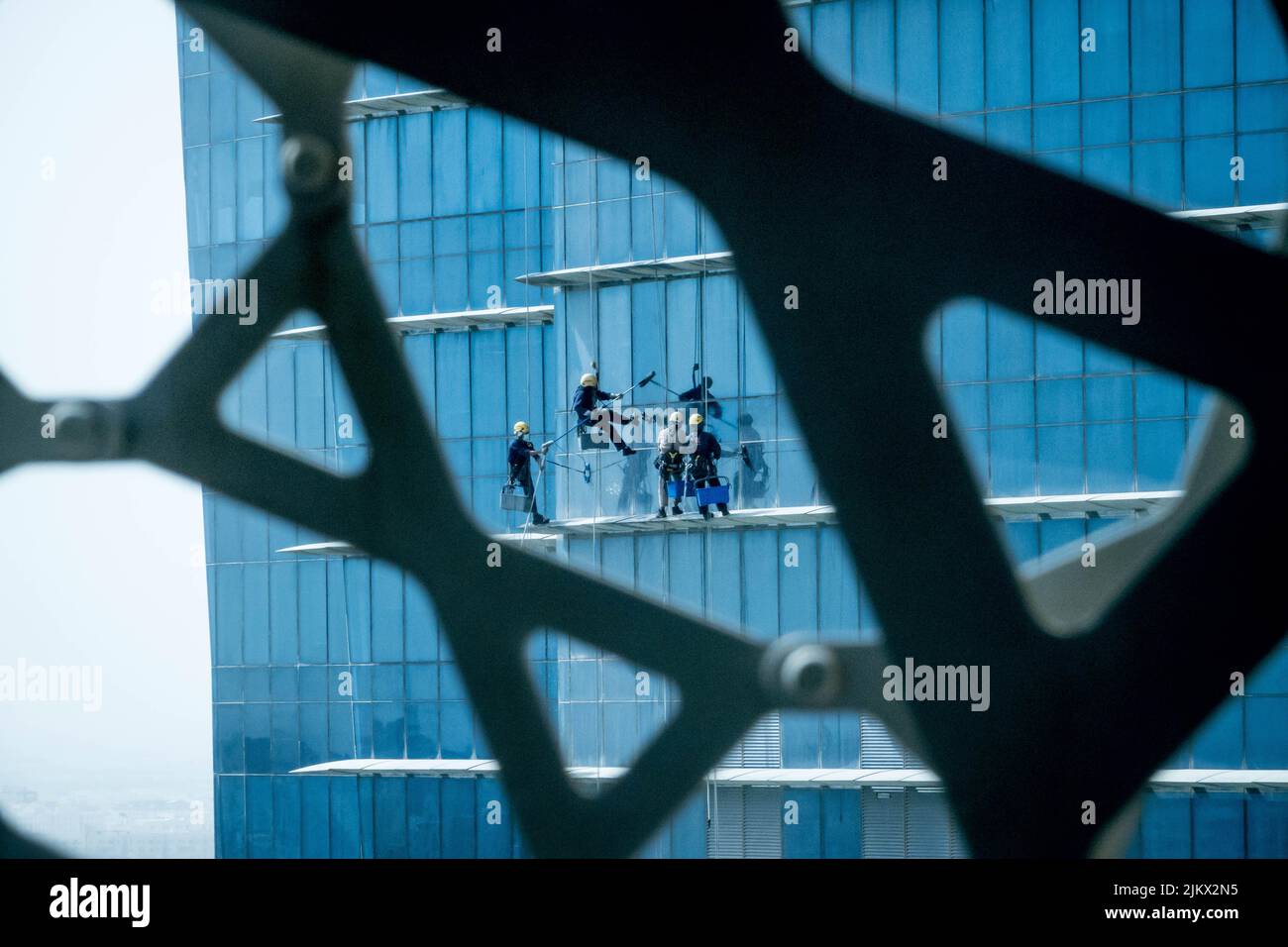 A number of men cleaning the windows of towers in Doha, Qatar Stock ...