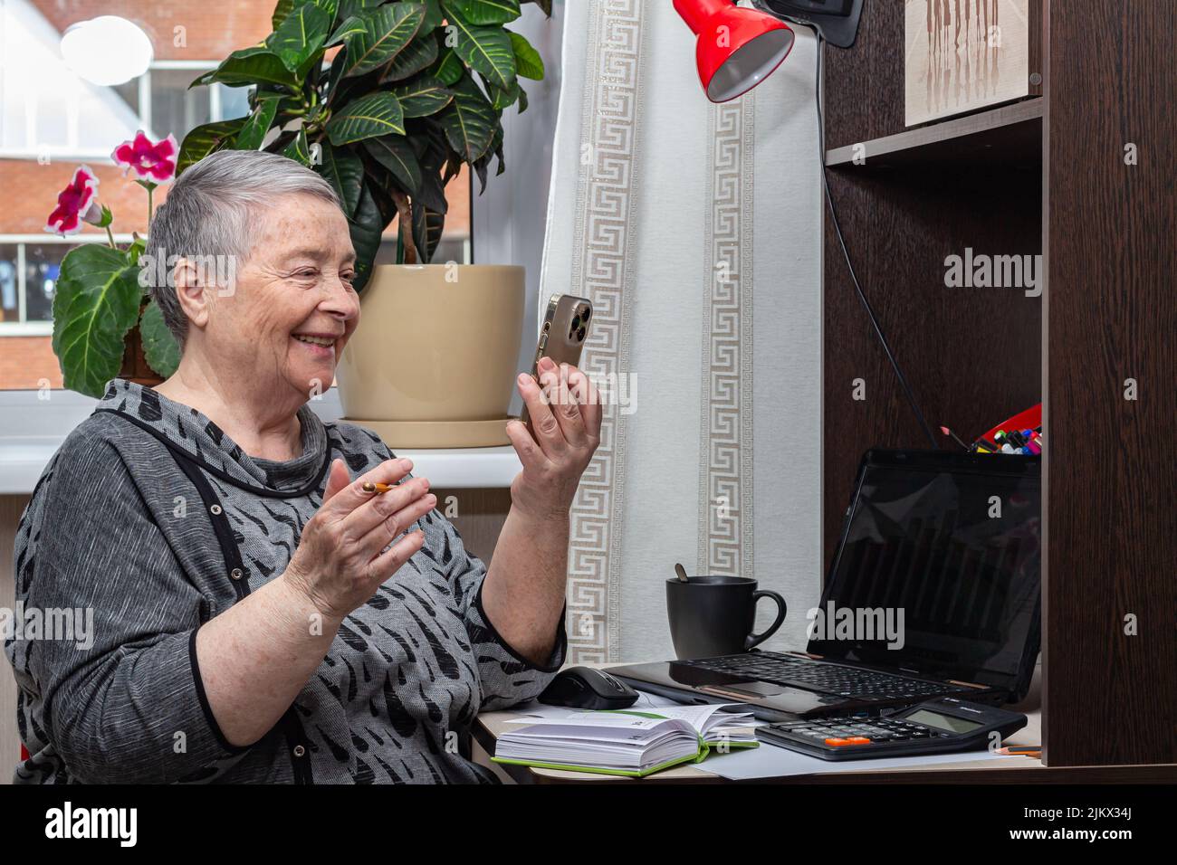 senior business woman talking on video call at home. using technology ...