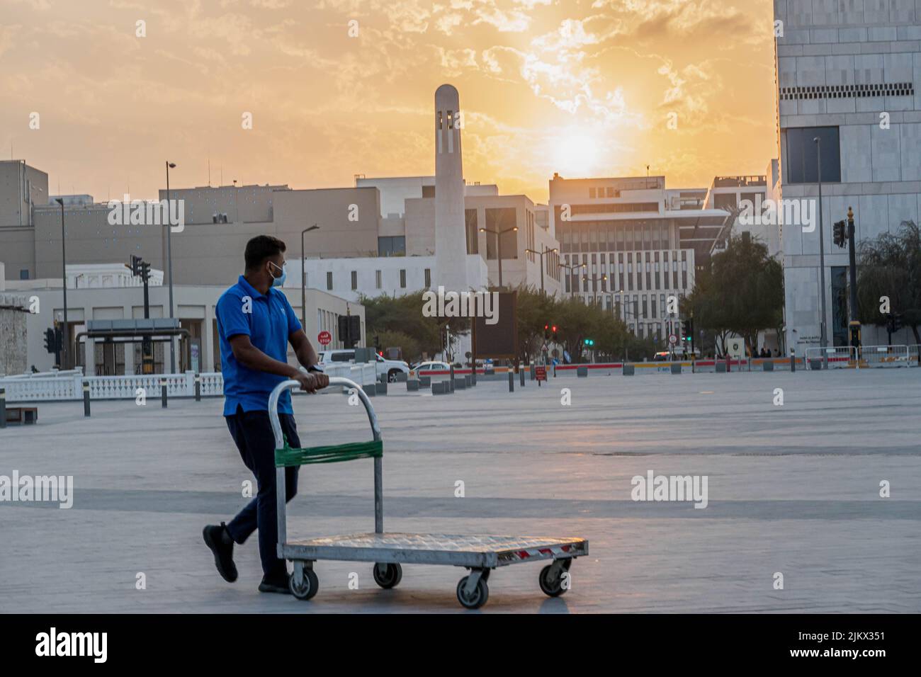 Guy pushing a box trolley in Souq Waqif, a marketplace in Doha, in the ...