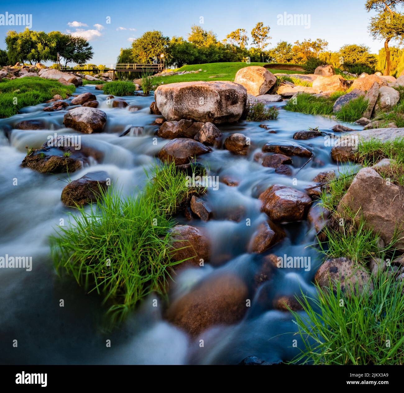 A vertical closeup shot of a river flowing through the rocks in the ...