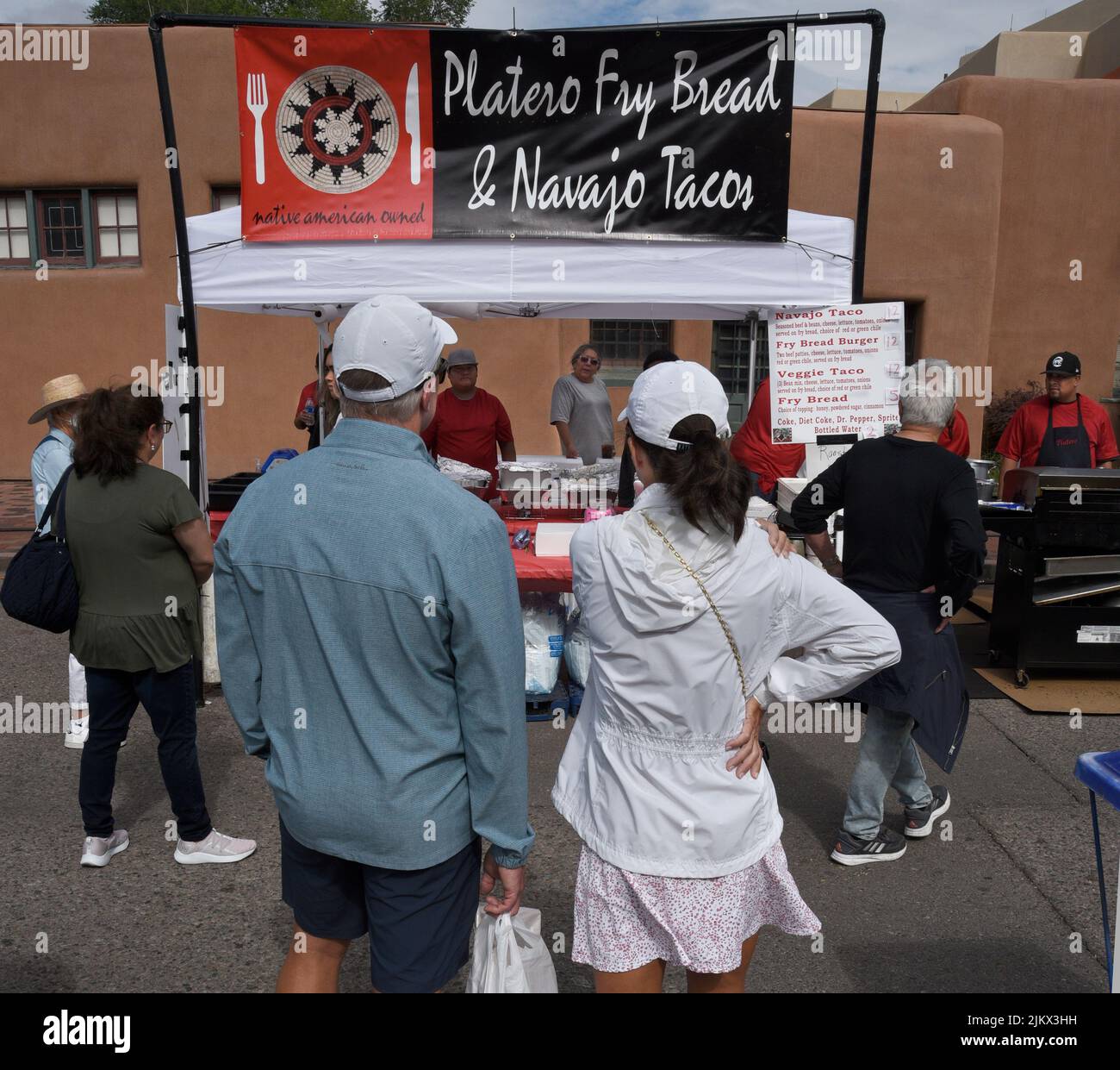 Customers purchase lunch at a Native-American food vendor at an outdoor ...