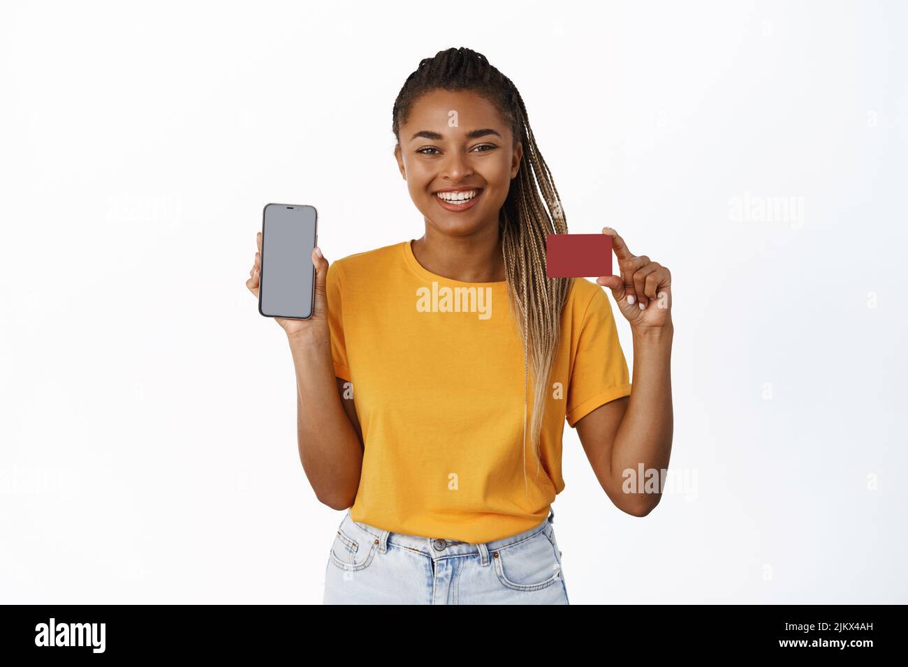 Cheerful african american woman shows mobile phone appliation on screen ...